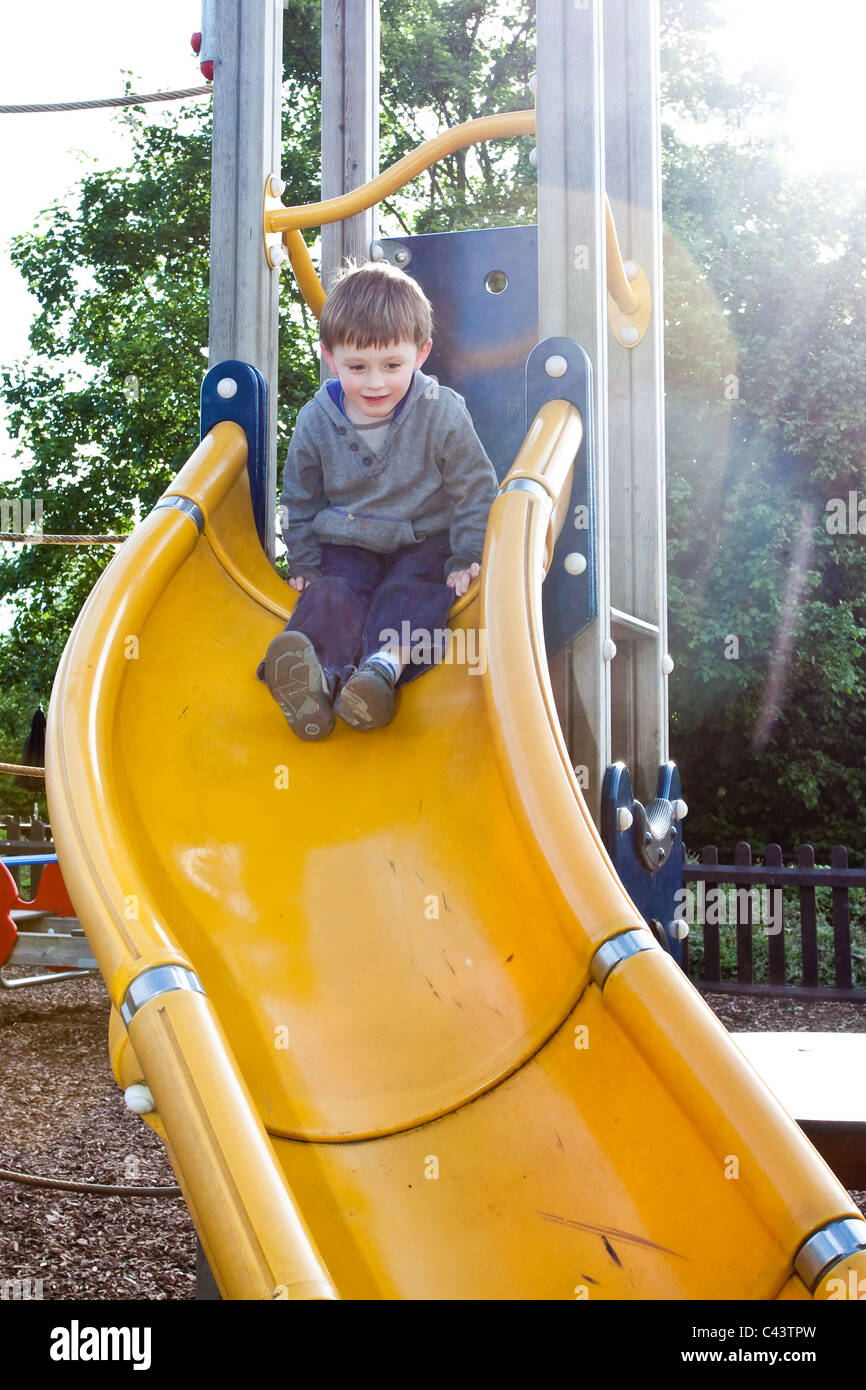 Child playing on a slide Stock Photo - Alamy