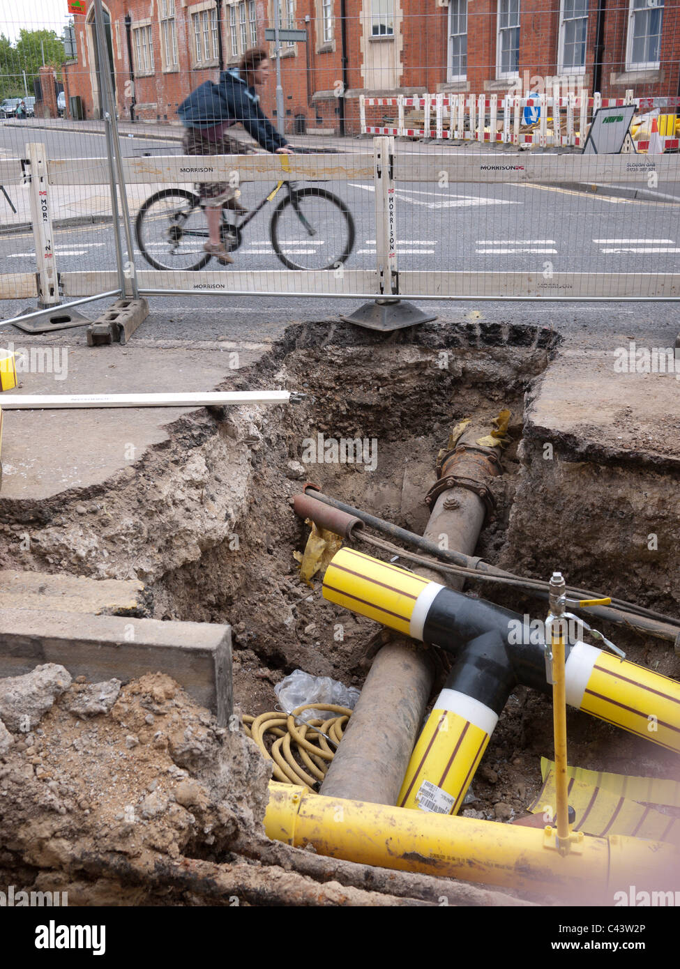 new pipes being installed in hole under road Stock Photo - Alamy