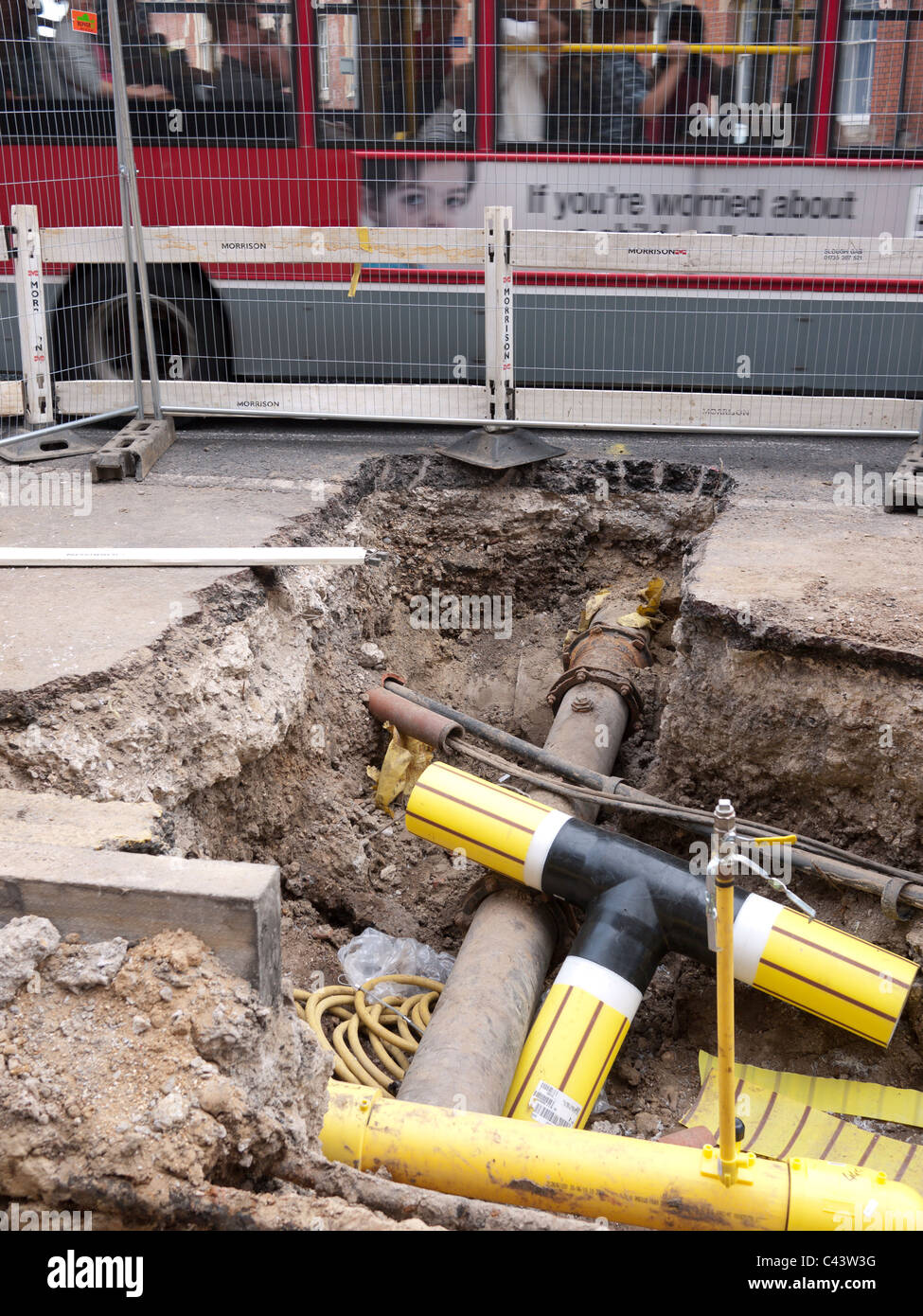 new pipes being installed in hole under road Stock Photo - Alamy