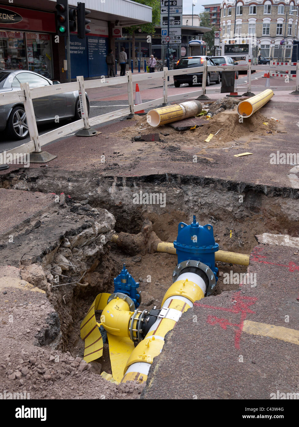 new pipes being installed in hole under road Stock Photo - Alamy