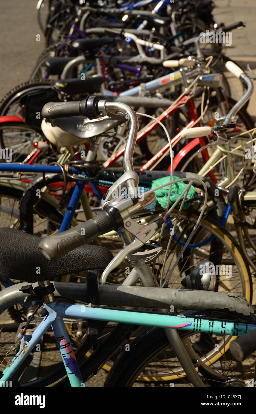 Push-bikes parked up in a city centre. The viewpoint suggests a tangle ...