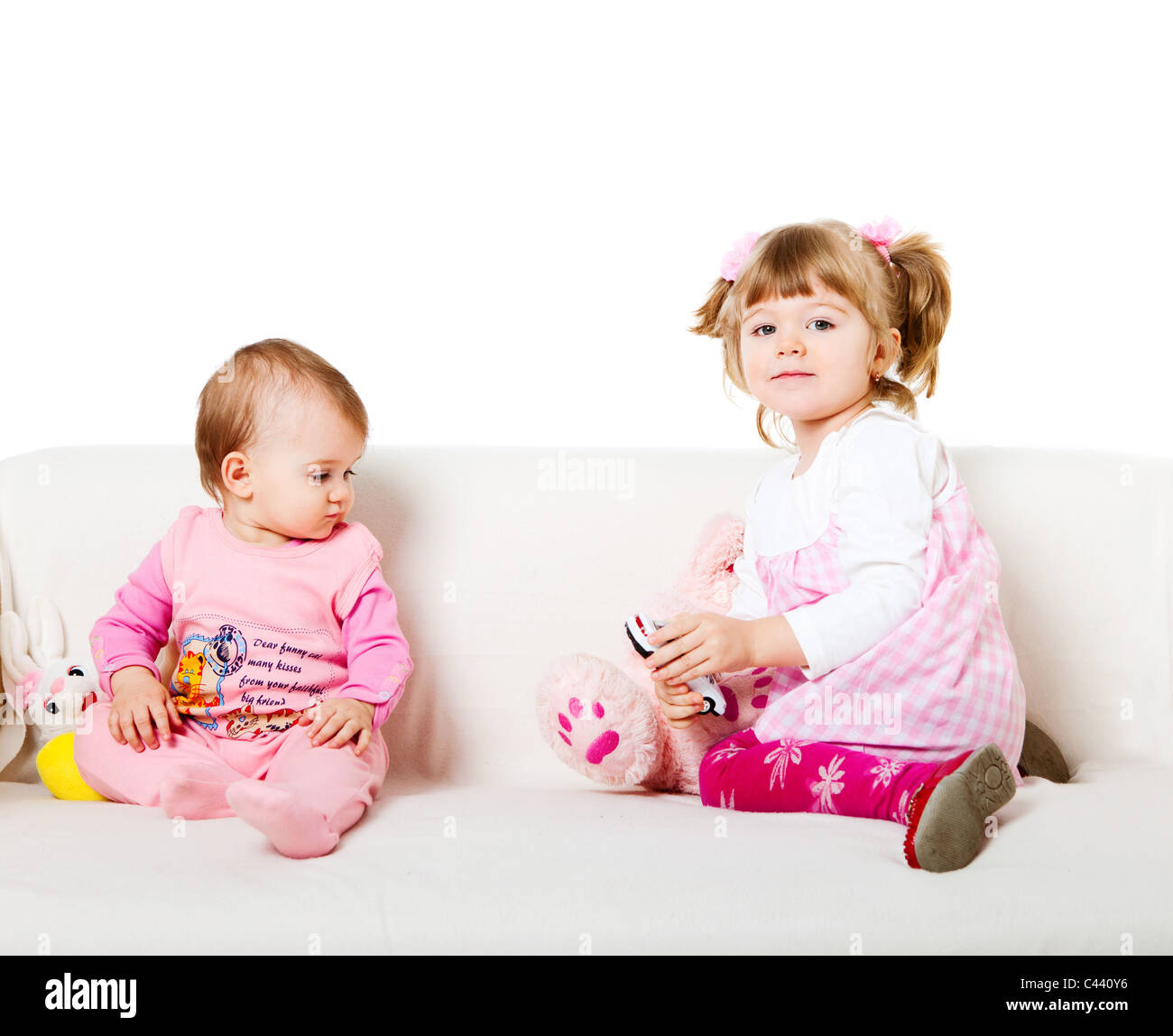 two adorable kids sitting on the sofa Stock Photo - Alamy