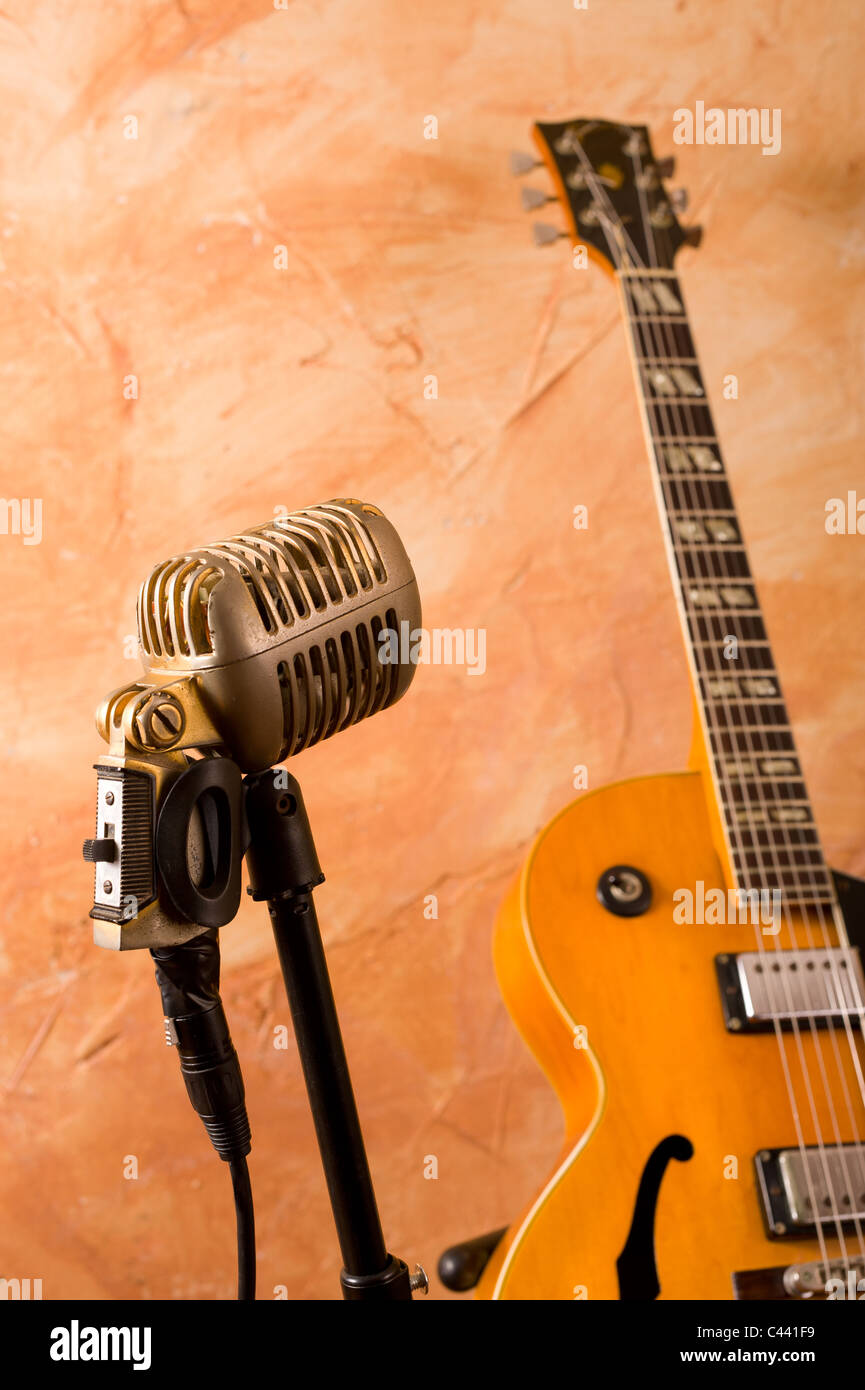 Vintage microphone and classic guitar waiting on stage Stock Photo - Alamy