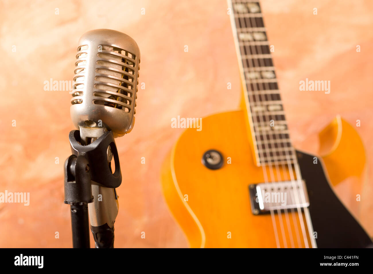 Vintage microphone and classic guitar waiting on stage Stock Photo - Alamy
