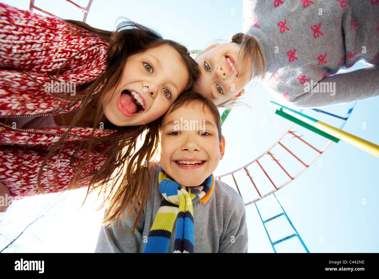 Below view of happy children looking and smiling at camera Stock Photo ...