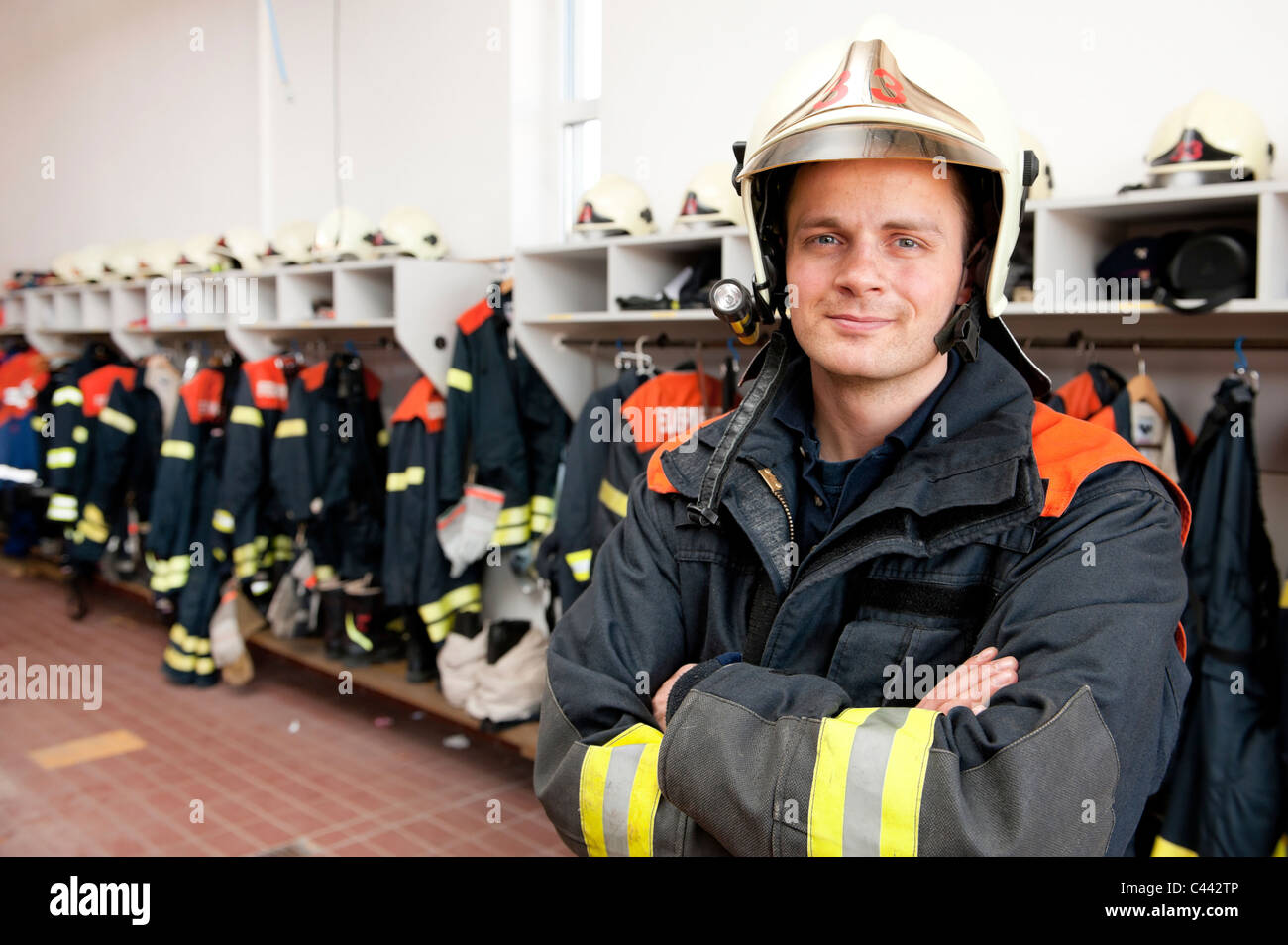 Picture from a young and successful firefighter at work Stock Photo - Alamy