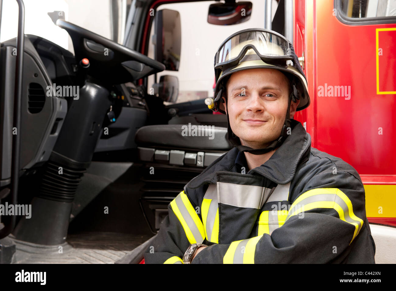 Picture from a young and successful firefighter at work Stock Photo - Alamy