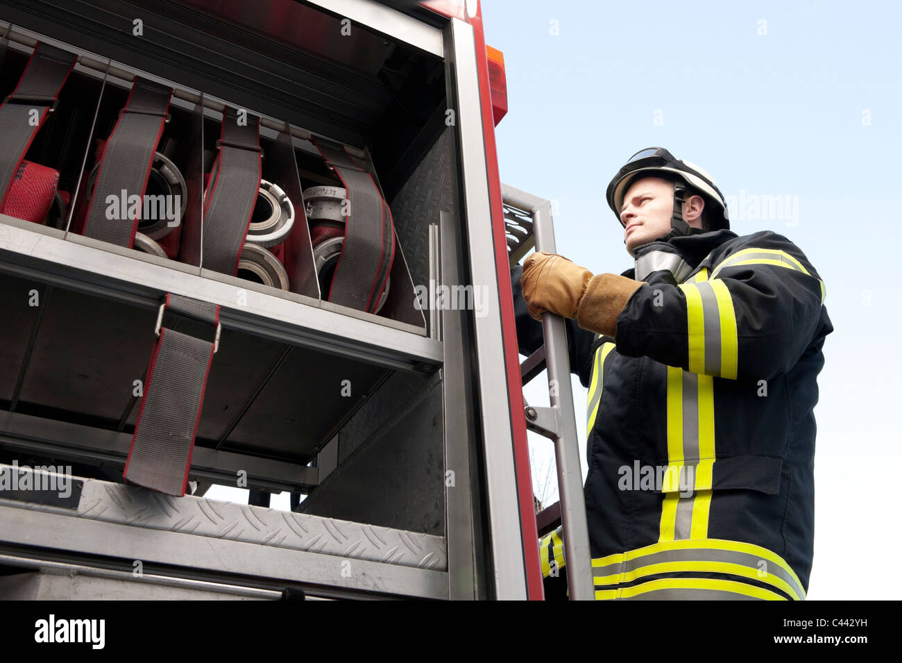 Picture from a young and successful firefighter at work Stock Photo - Alamy