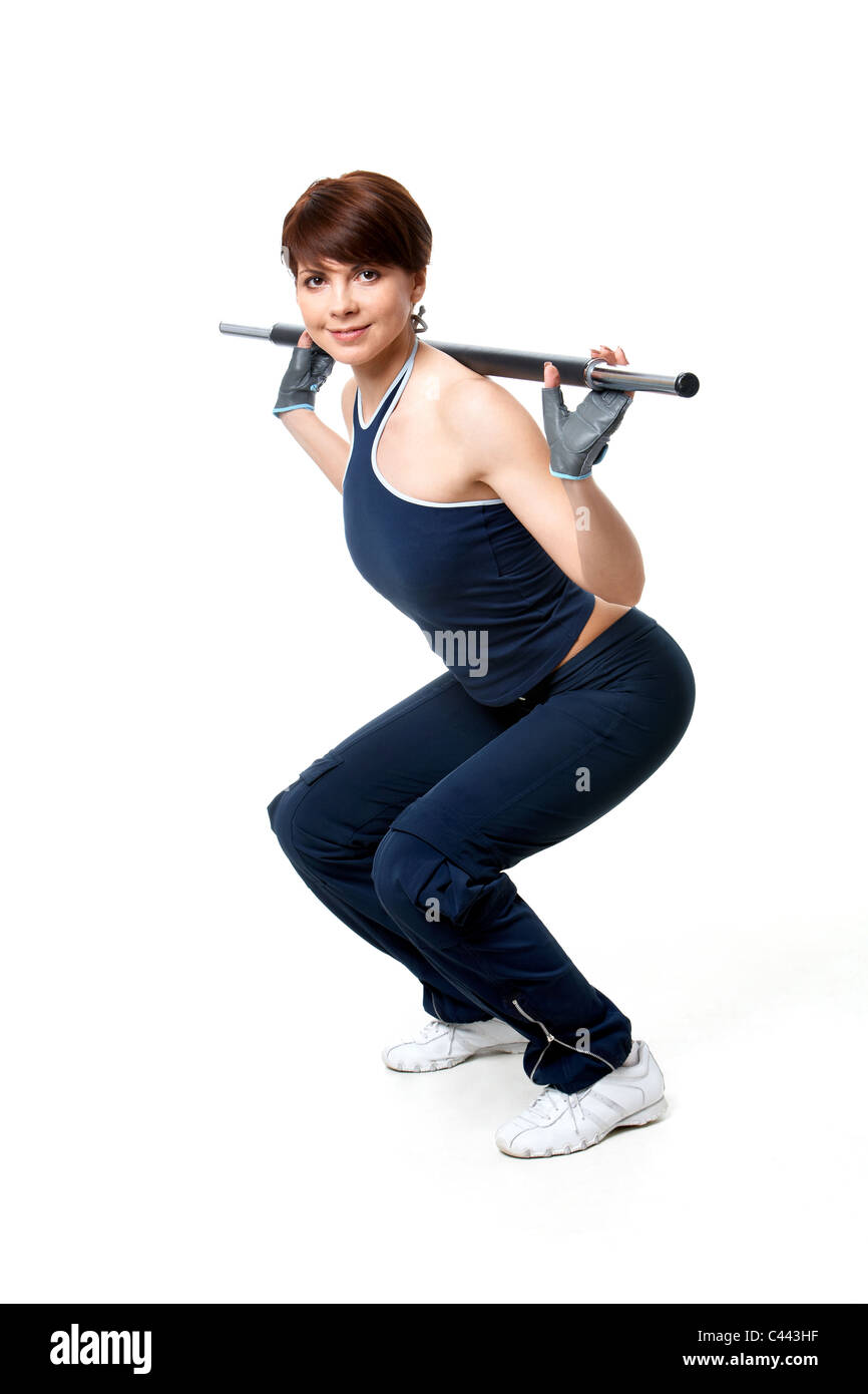 Image of sporty girl standing on the floor and doing exercise with ...