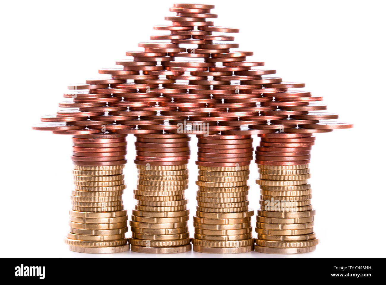 a house build of coins in front of white background Stock Photo - Alamy