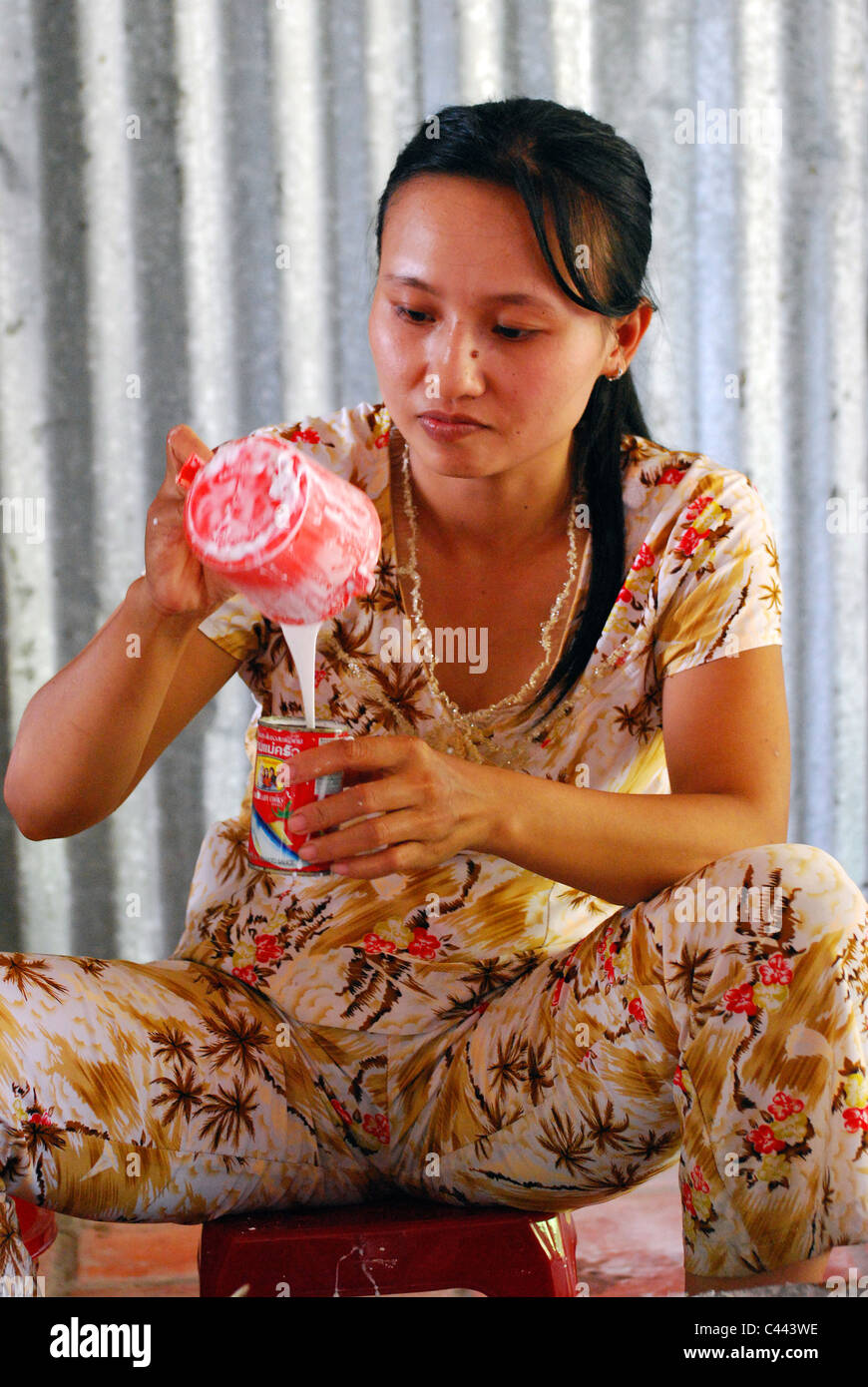 Vietnamese girl mixing milk for sweet making Stock Photo - Alamy