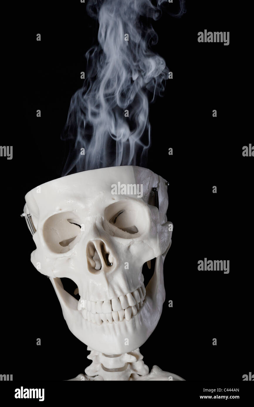 A skeleton with smoke coming out of its skull Stock Photo - Alamy