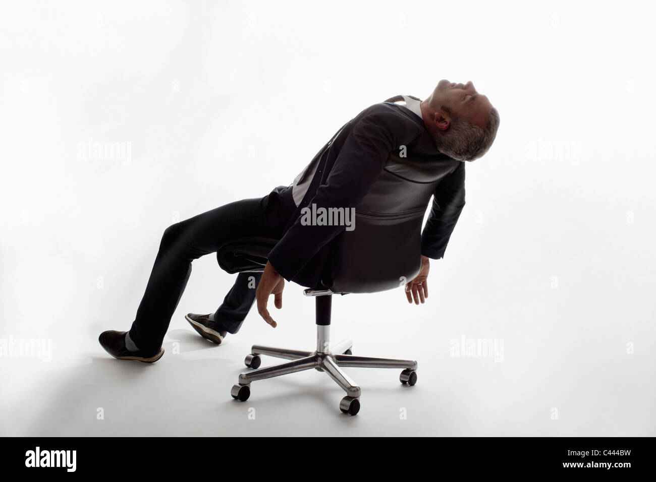 An exhausted businessman sleeping in an office chair Stock Photo - Alamy