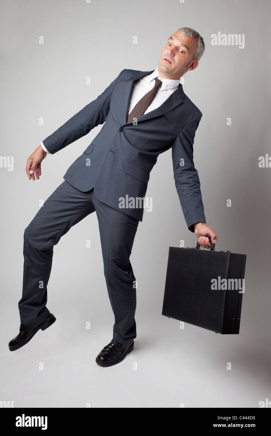 A businessman off balance Stock Photo - Alamy