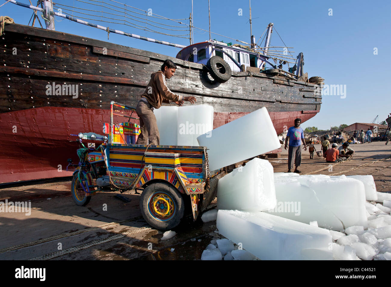 Man unloading big ice blocks used to freeze fish on board. Vanakbara ...