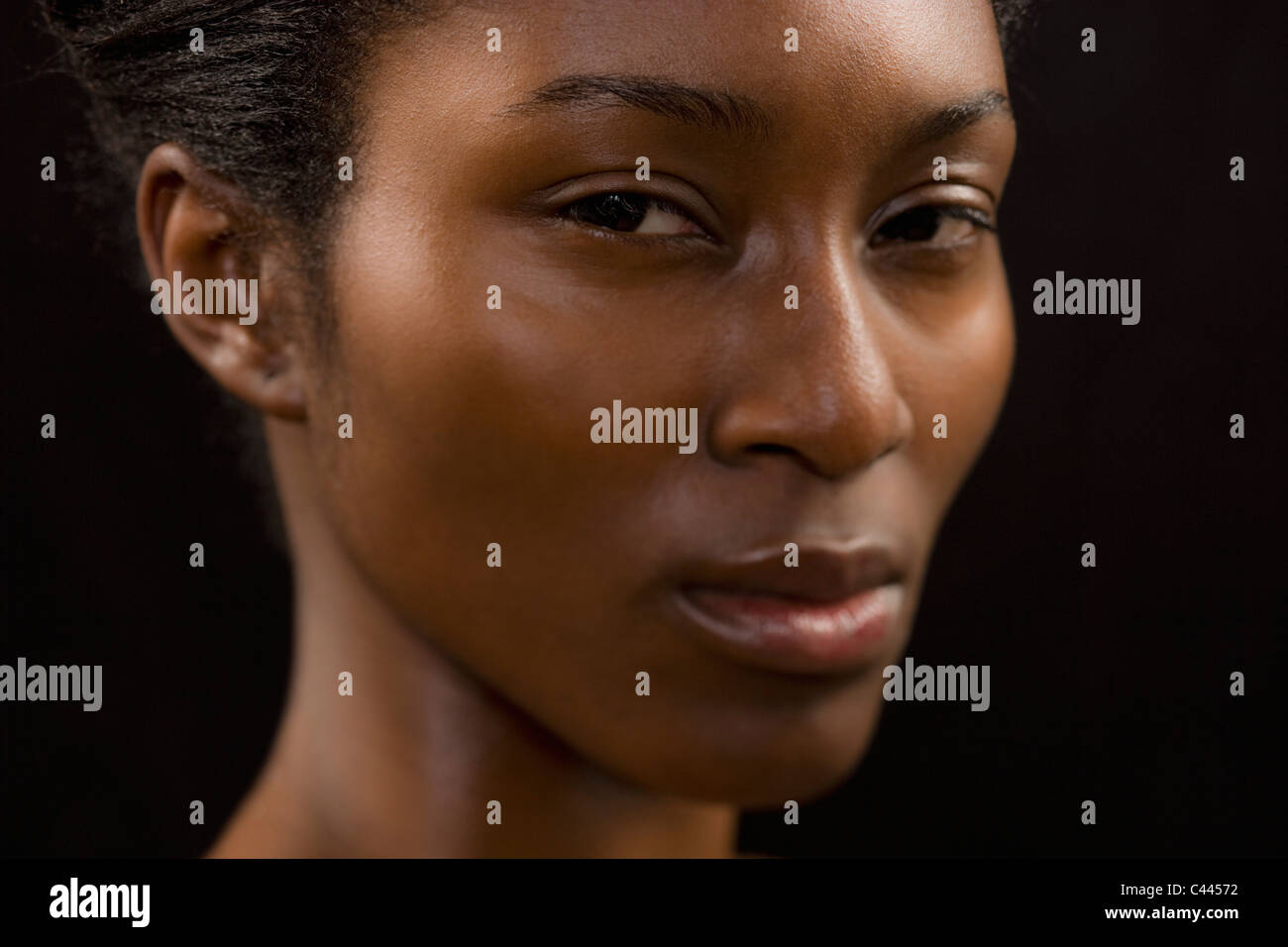 Close-up of a young woman scowling Stock Photo - Alamy