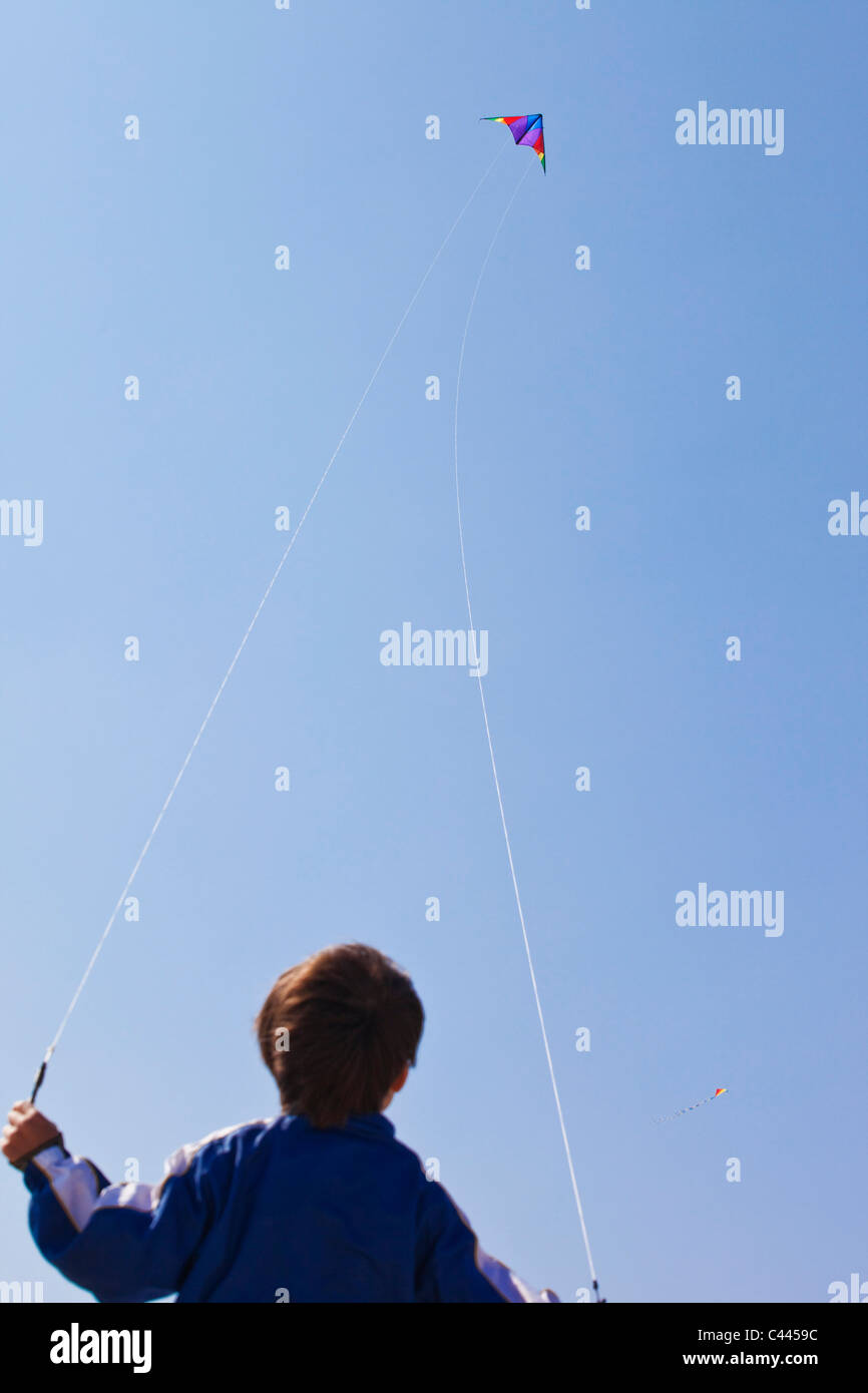 Rear view of a boy flying a kite Stock Photo - Alamy