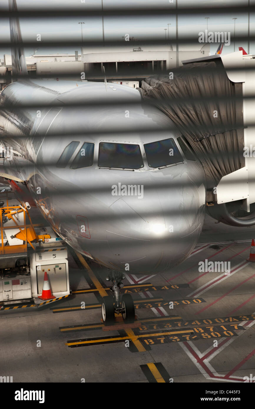 View through a window of an airplane connected to a passenger boarding ...