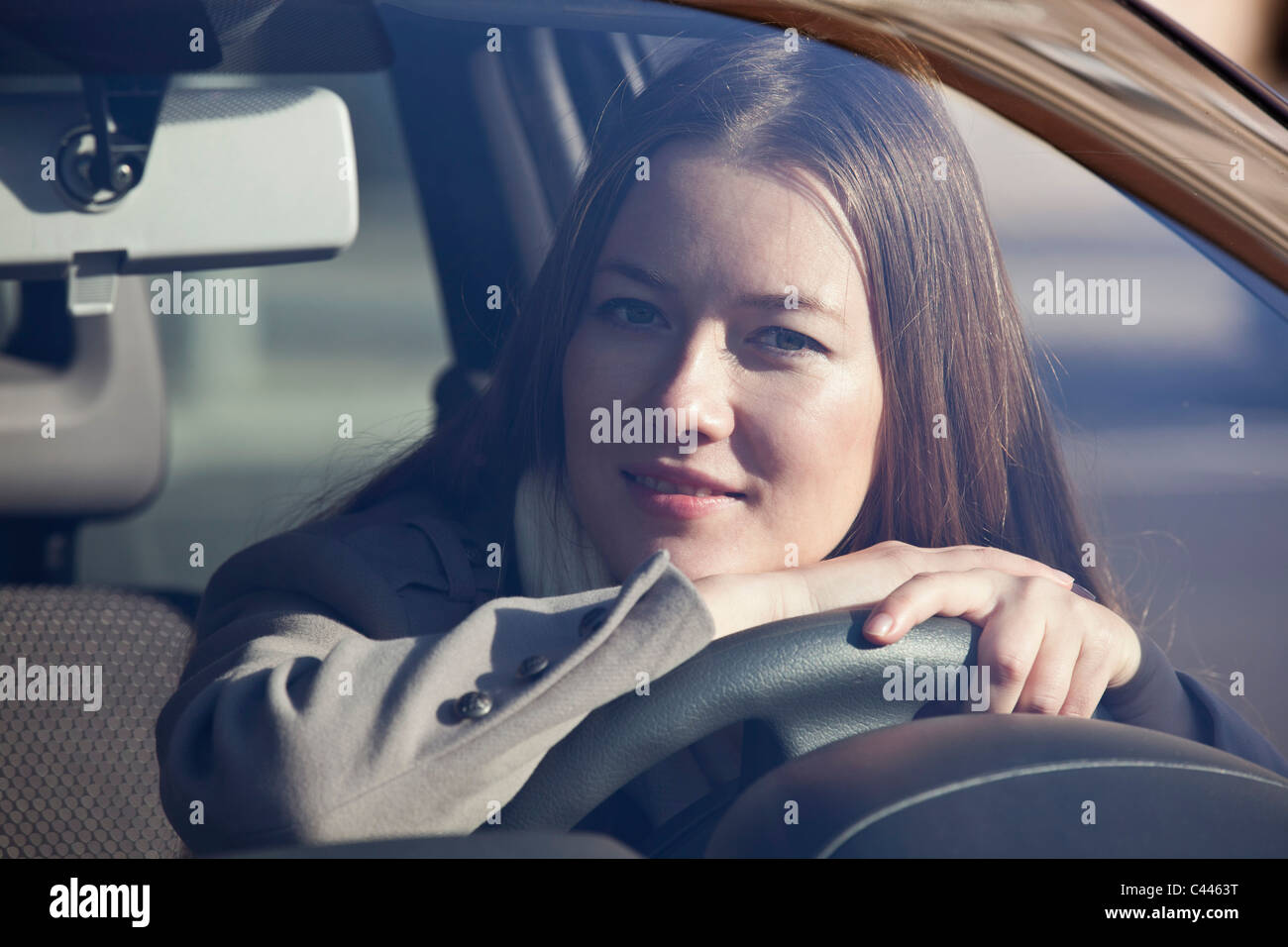 Woman looking out car window Stock Photo - Alamy