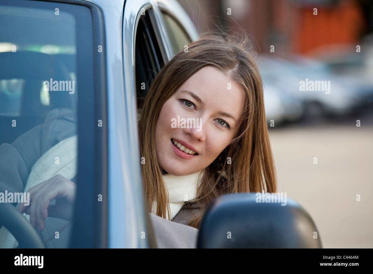 Woman driver with head out of window Stock Photo - Alamy
