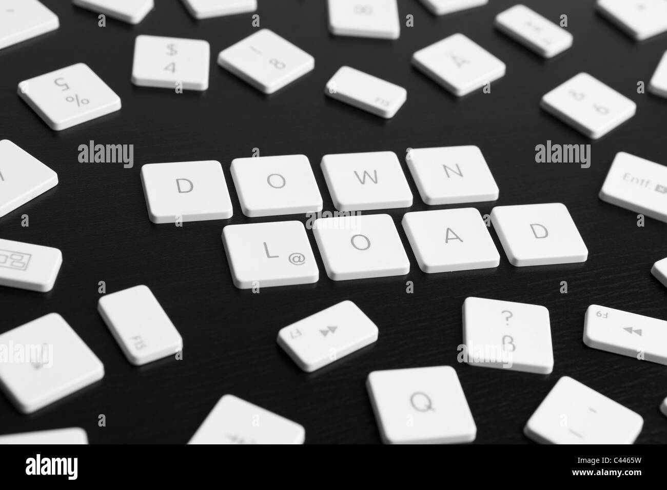 Computer keys spelling the words DOWN LOAD Stock Photo - Alamy