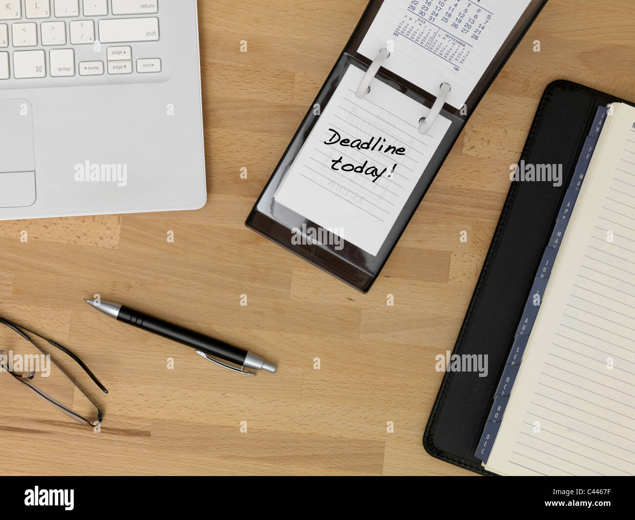An office desk with office items in a work place scene Stock Photo - Alamy