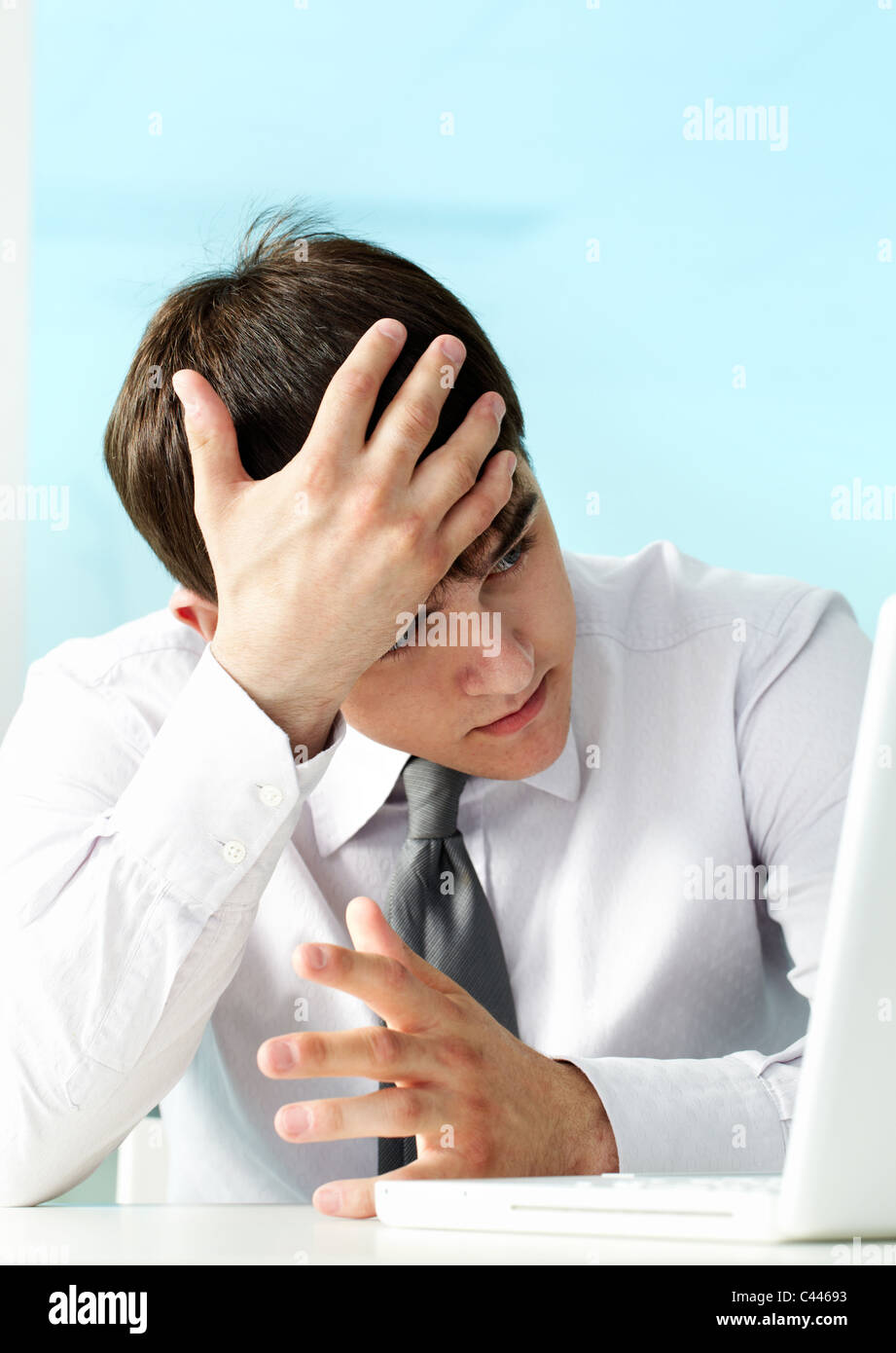 Portrait of upset man with laptop in office Stock Photo - Alamy