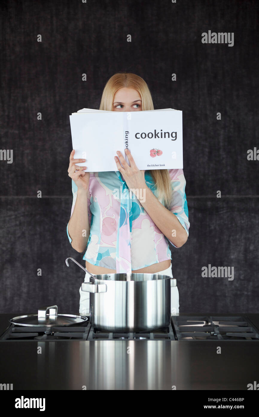 Woman cooking, thinking about the recipe Stock Photo - Alamy