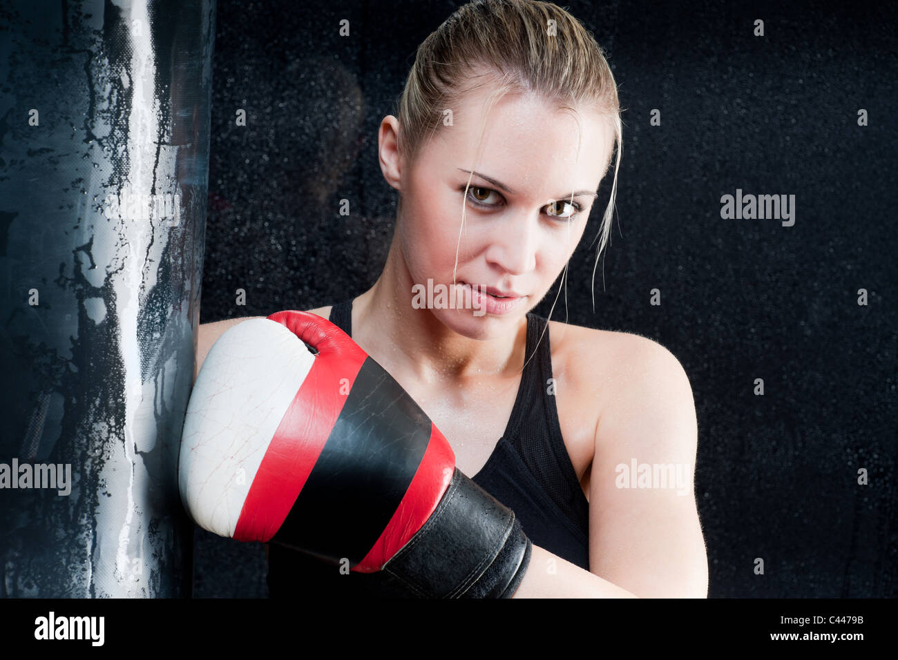 Boxing training woman with punching bag in gym wear gloves Stock Photo ...