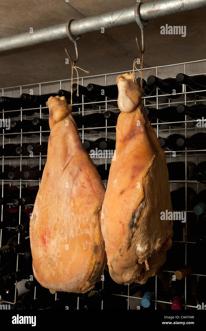 Two cured hams hanging in a cellar Stock Photo - Alamy