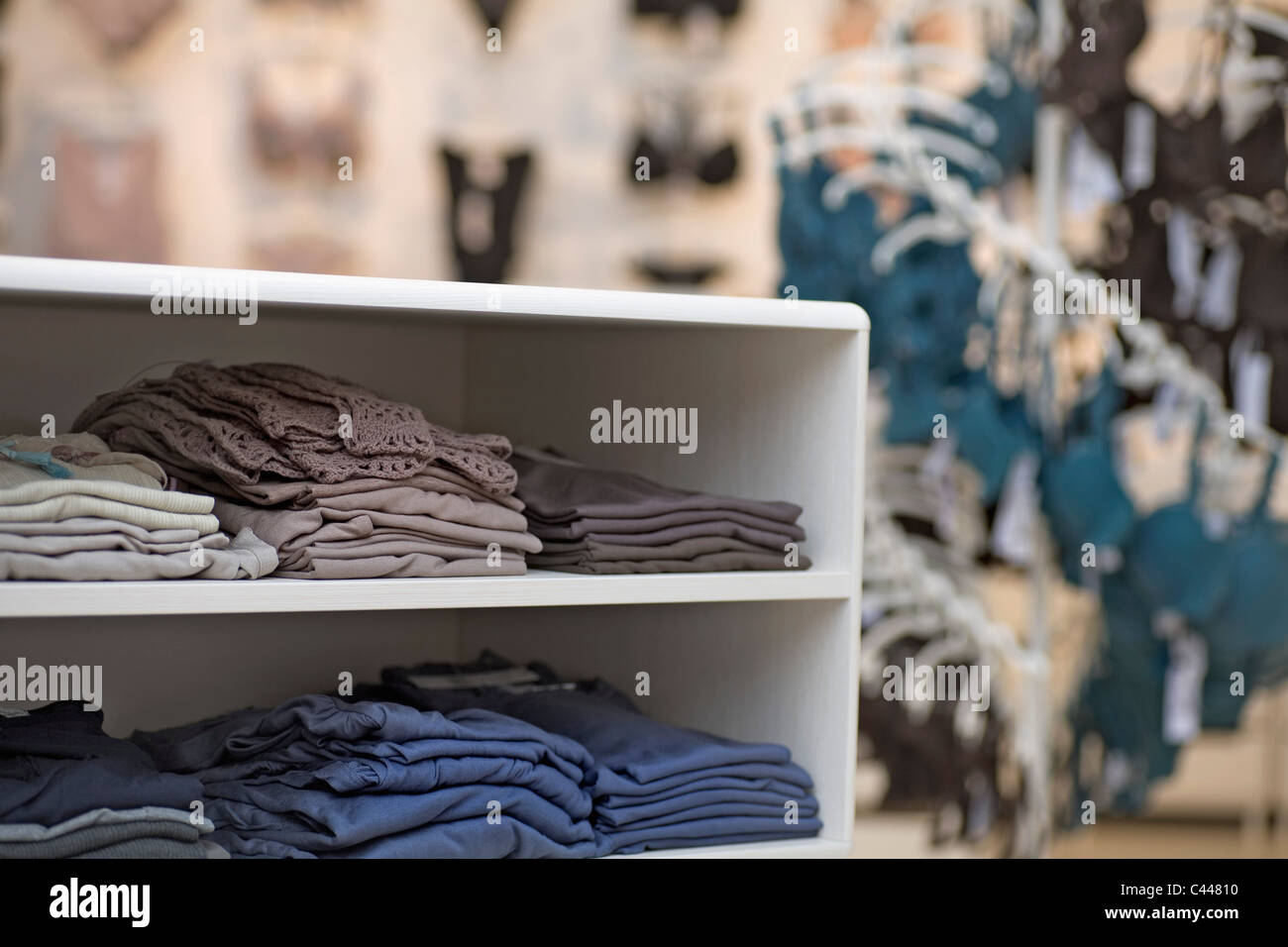 Folded t-shirts in a clothing store Stock Photo - Alamy