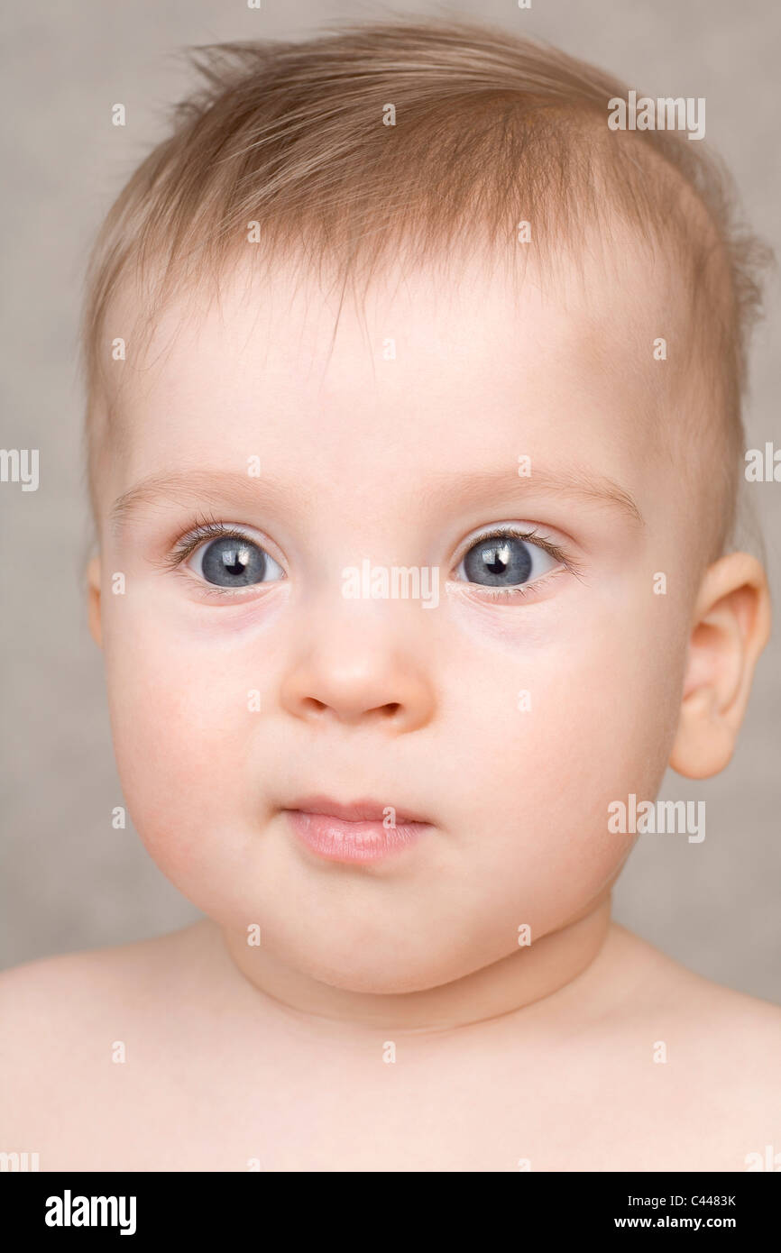 A baby boy staring blankly off camera Stock Photo - Alamy