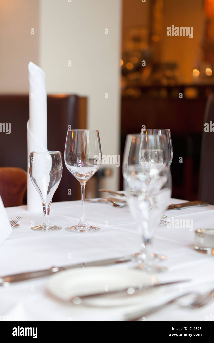 A elegantly set dining table in a restaurant Stock Photo - Alamy