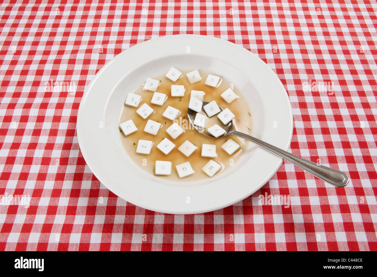A bowl of soup with various computer keys floating in it Stock Photo ...