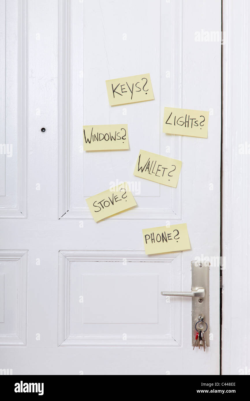 Adhesive notes on a front door with various reminders Stock Photo - Alamy