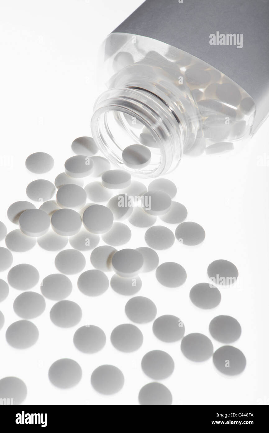 Pills spilling from a pill bottle Stock Photo - Alamy