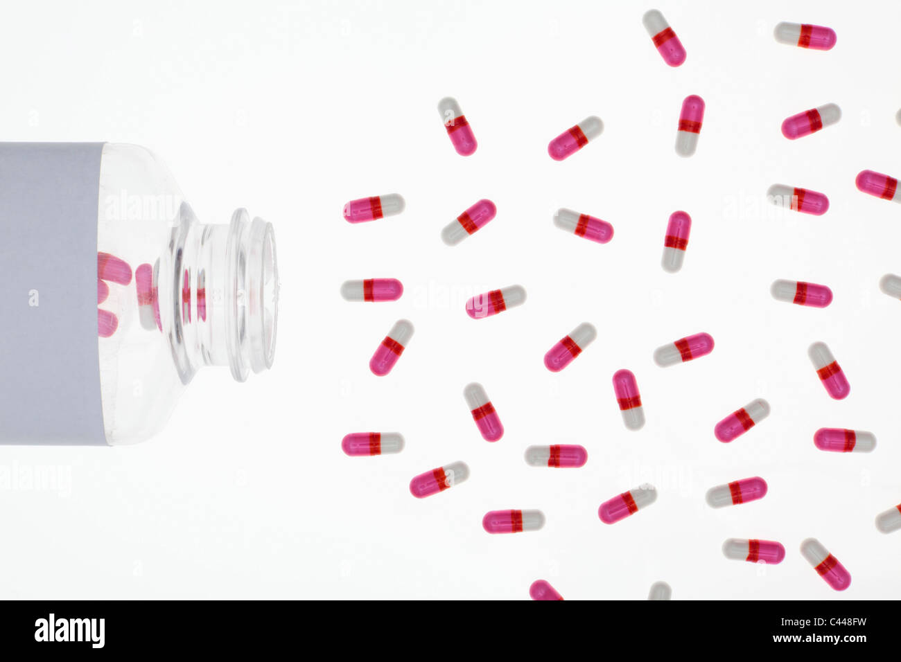 Capsules spilling from a pill bottle Stock Photo - Alamy