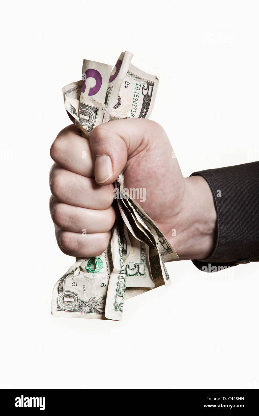 A man gripping a wad of US paper currency, close-up of hand Stock Photo ...