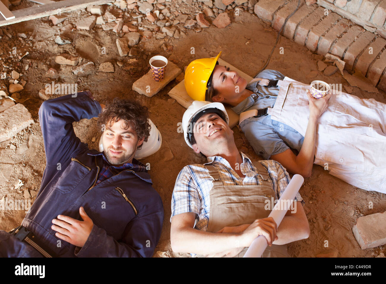 Three construction workers taking a coffee break Stock Photo - Alamy