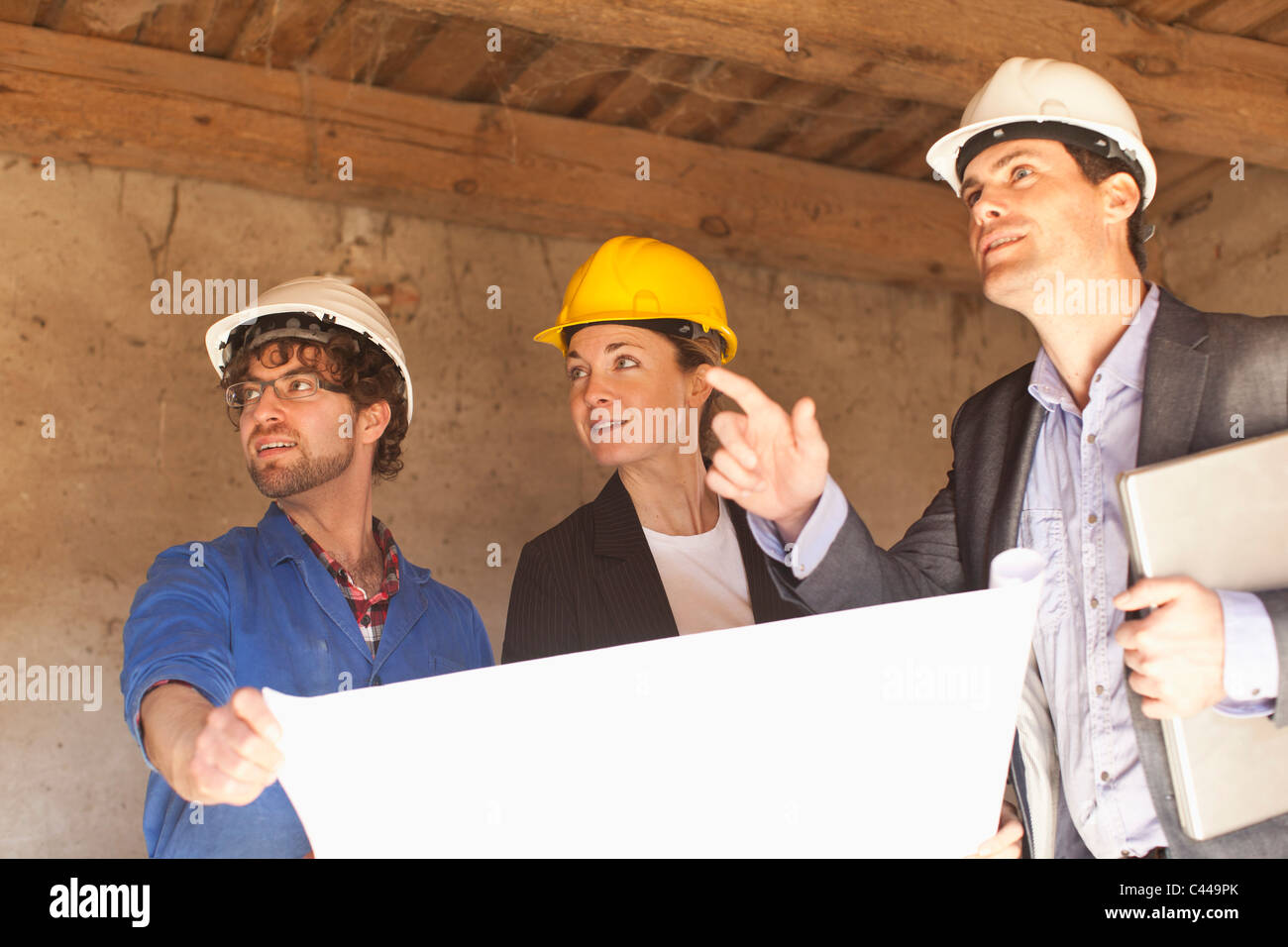Architects and a building contractor at a building site Stock Photo - Alamy