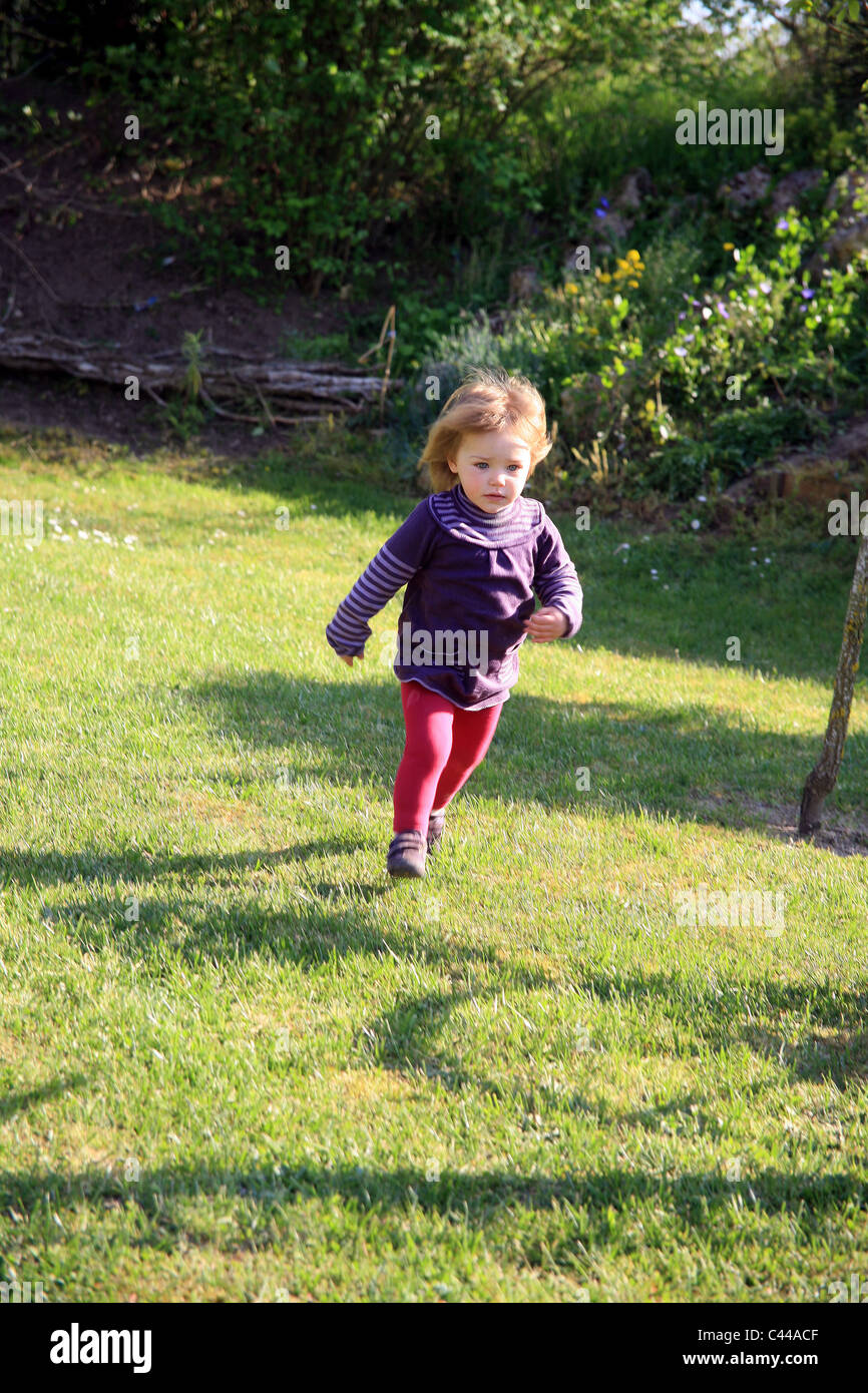 Blonde child running park hi-res stock photography and images - Alamy