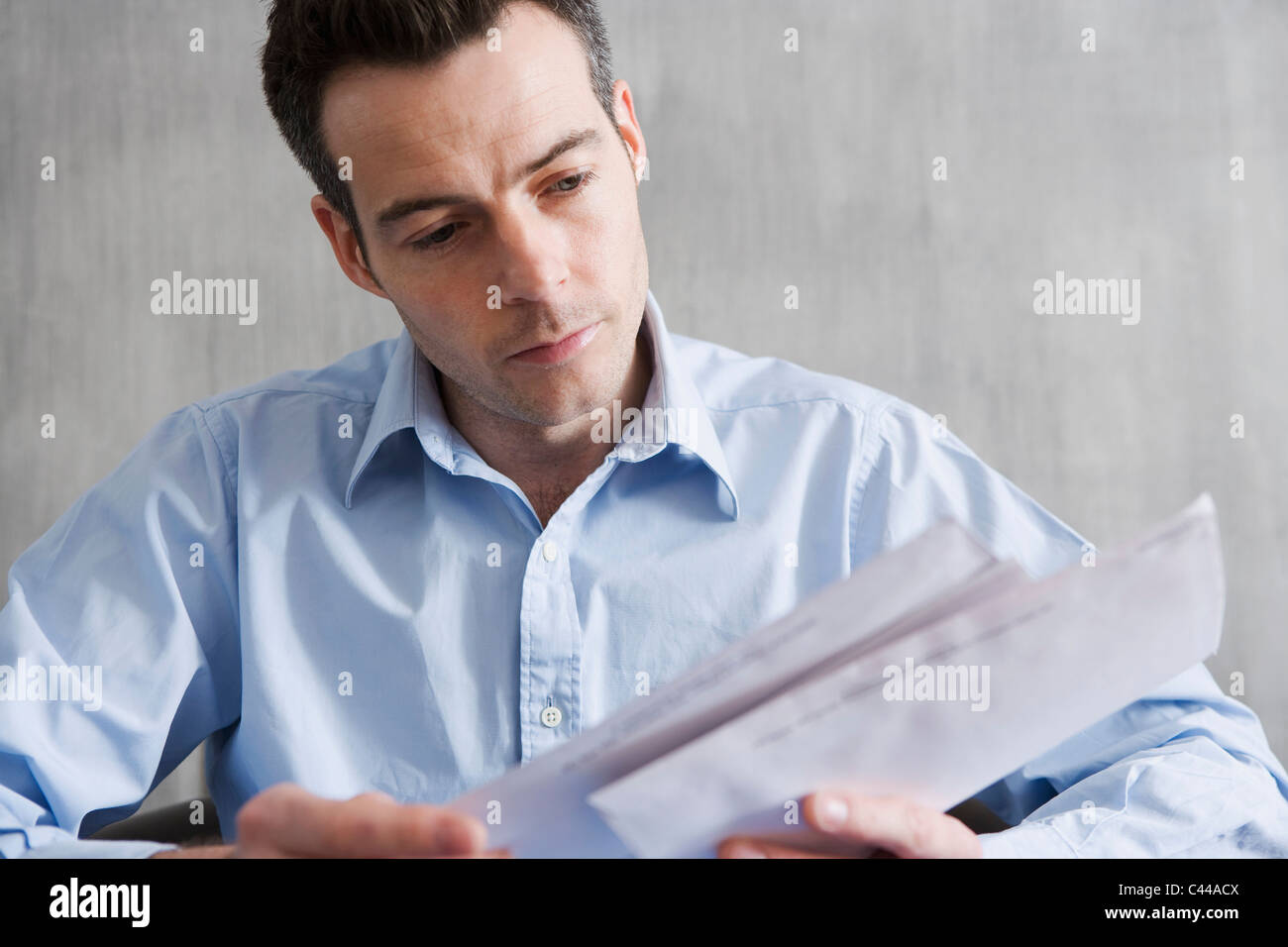 A man looking through his mail Stock Photo - Alamy