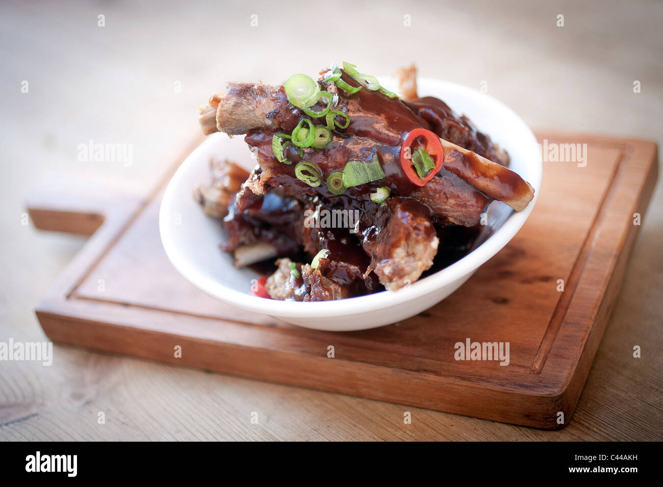 A gourmet dish of sticky Chinese style spare ribs served with chili ...