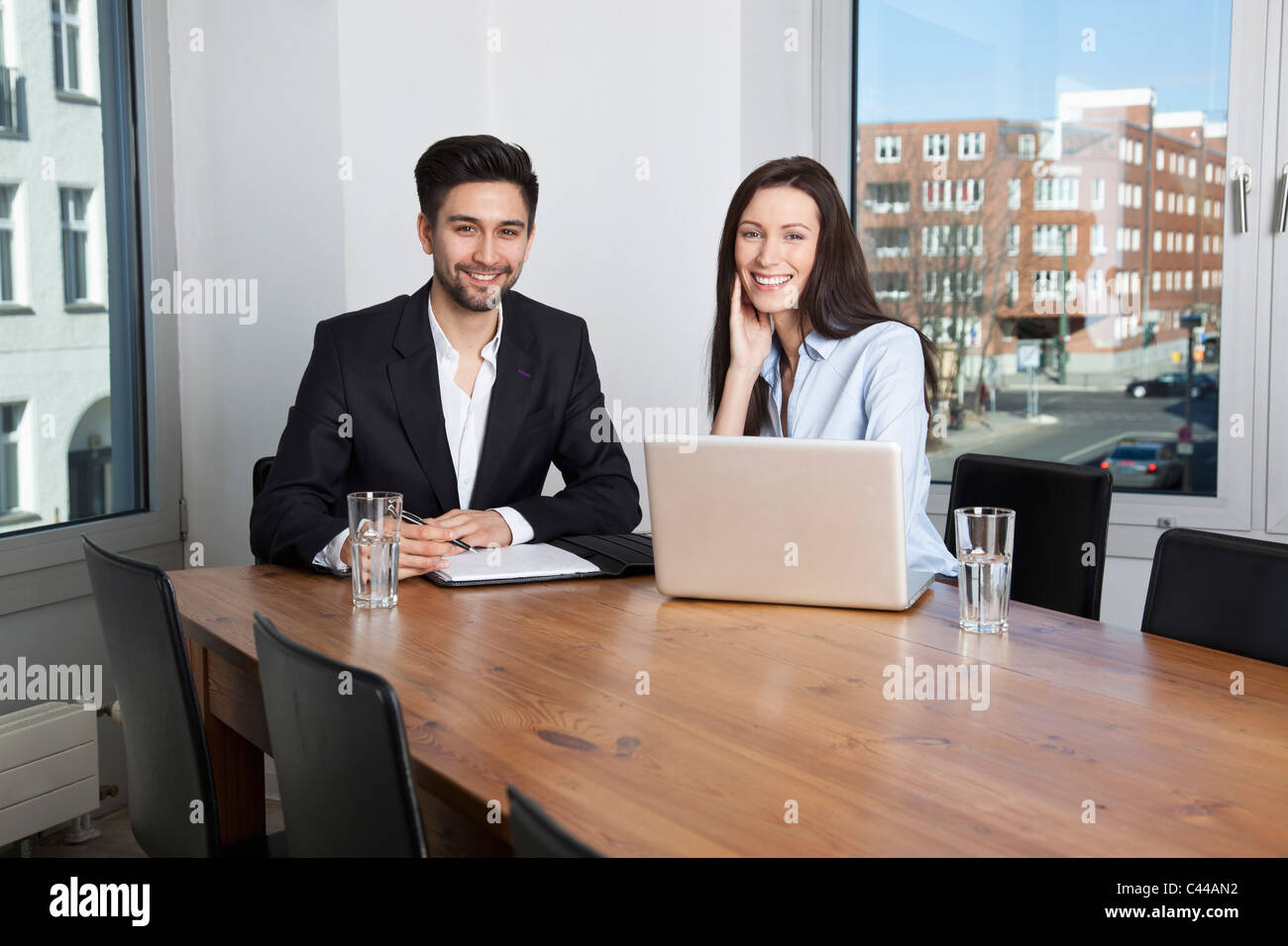 A businessman and businesswoman having a meeting in a board room Stock ...