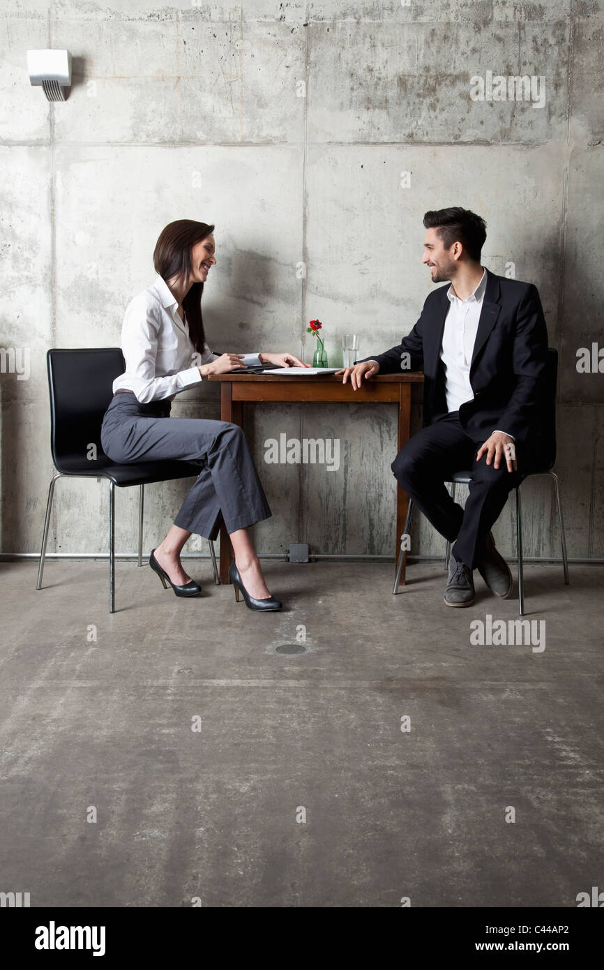 A businessman and businesswoman having a meeting in a modern office ...