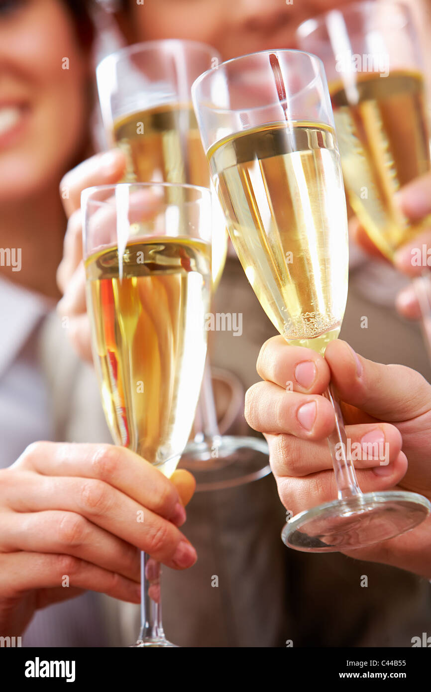 Hands holding toasting champagne flutes hi-res stock photography and ...