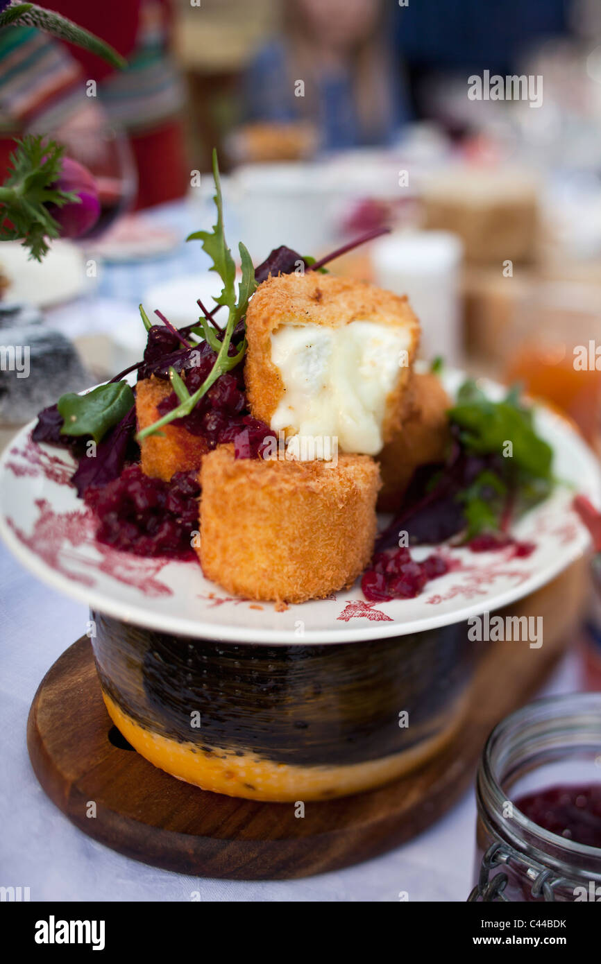 Fried camembert on plate on dining table outside Stock Photo - Alamy