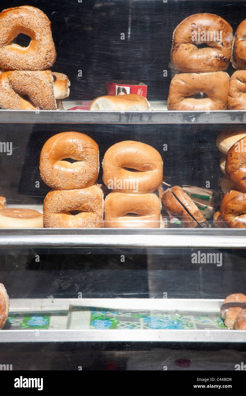 Selection of bagels on shelves behind a shop window Stock Photo - Alamy