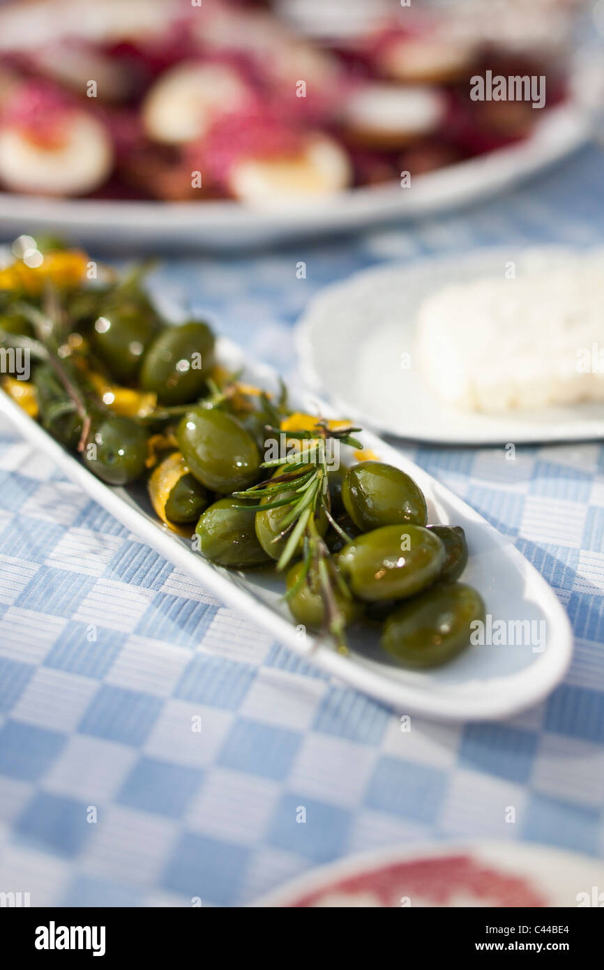 A long dish of green olives on a dining table outside Stock Photo - Alamy