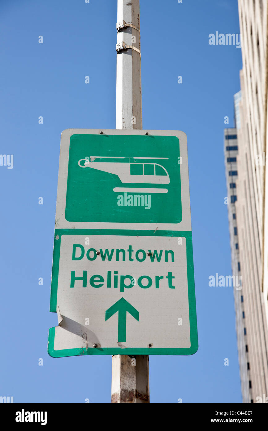 Sign saying 'Downtown Heliport' with direction arrow Stock Photo - Alamy